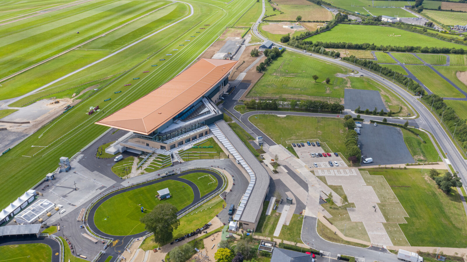 Floating copper roof marks out Grimshaw’s racecourse grandstand
