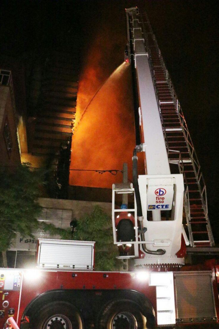 Fire Engines Photos - Aerials at work during a multiple alarms fire