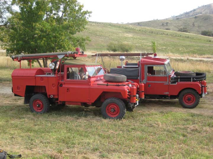 Group photo of two Australian Fire Land Rovers