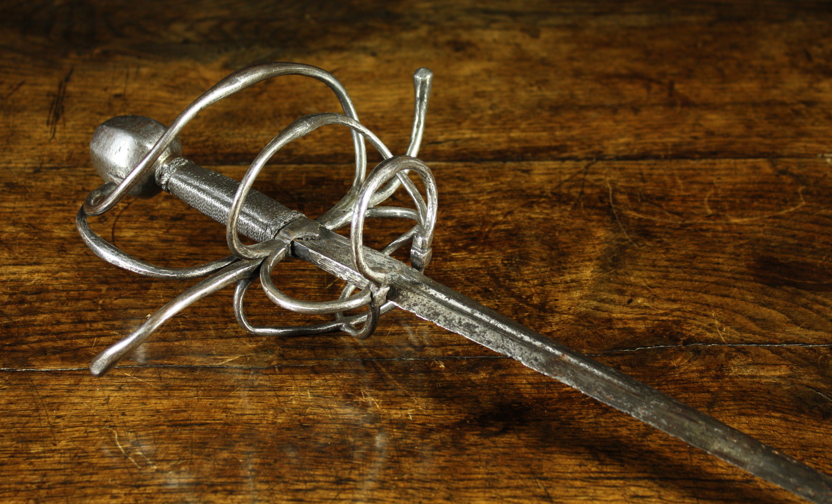 A 16th/17th Century Rapier. The swept basket hilt with counter swept ...