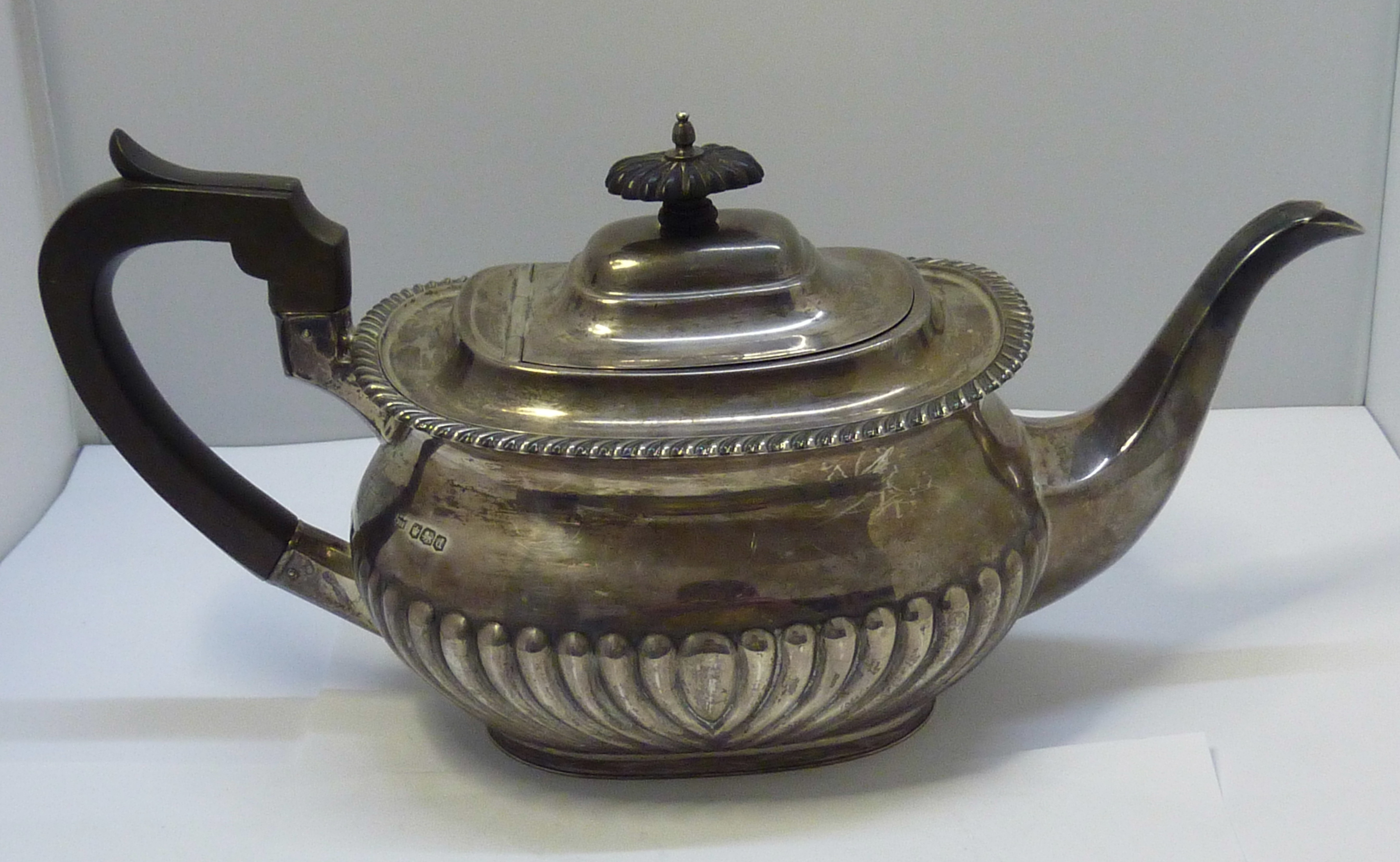 A George V Mappin and Webb silver teapot with ebonised handle and ...