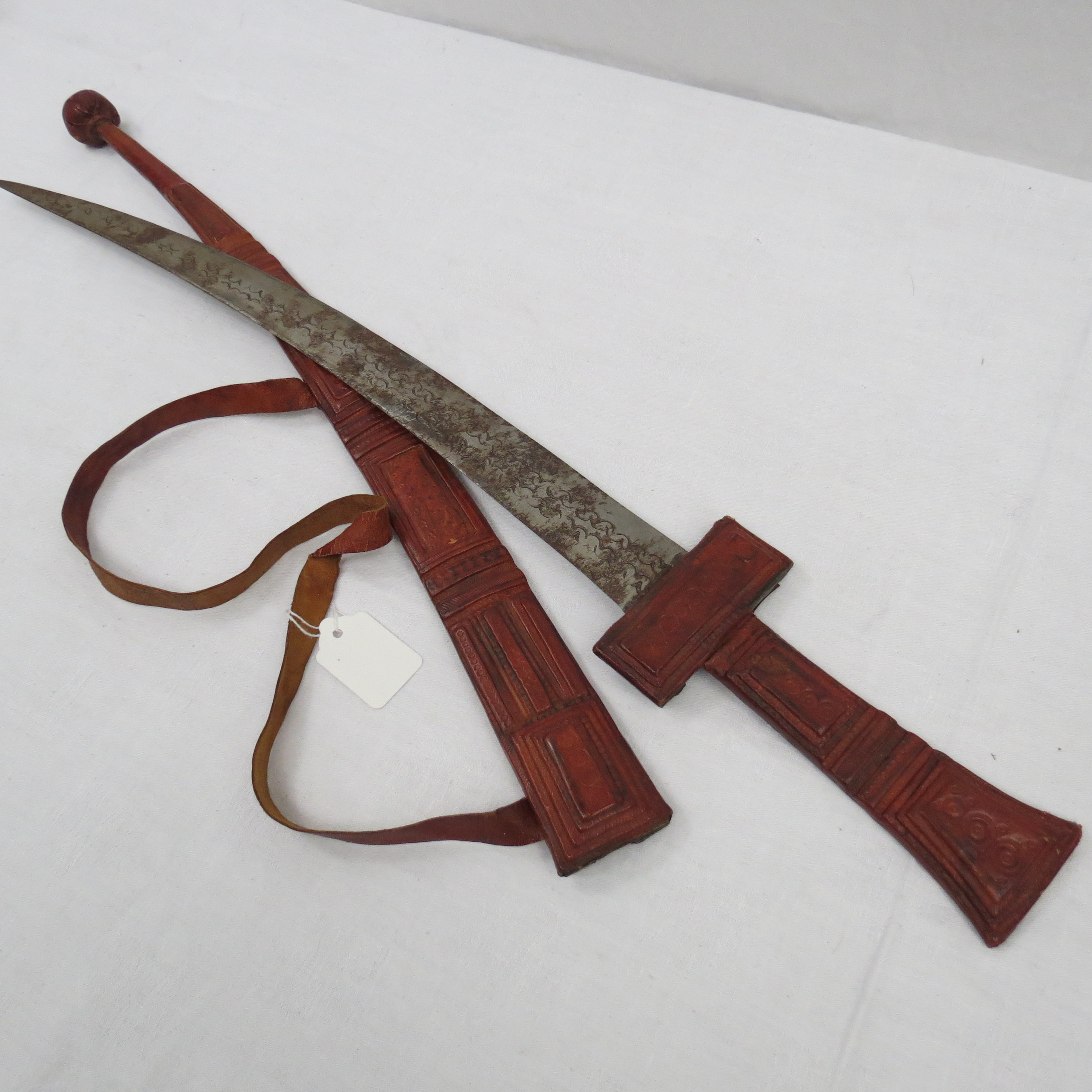 A 20th C. North African short sword, the curved blade engraved with ...