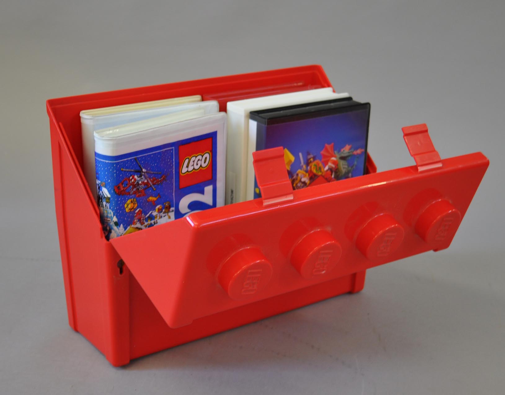 Red Lego brick carry case containing five Lego promotional VHS tapes ...