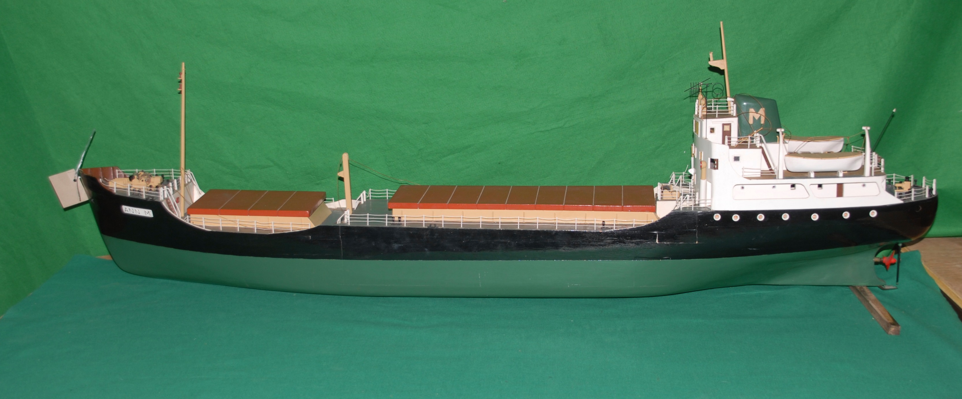 A large model of a cargo ship Ann M with two front hatches, the ...