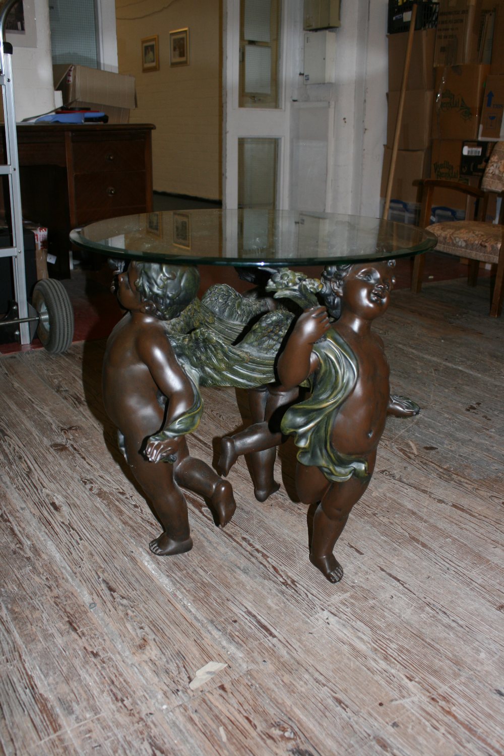 TABLE - A resin Cherub coffee table. The 3 bronze effect dancing ...