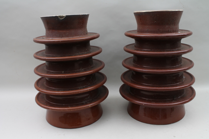 Two ceramic electricity pylon insulators, approx 43cm high.