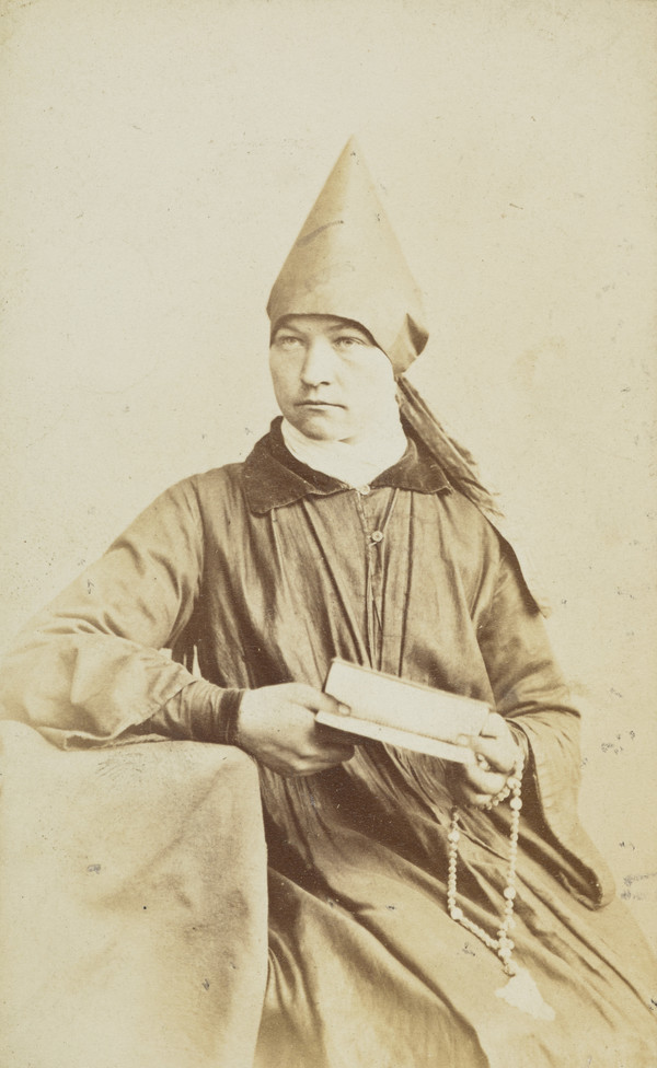 An 'old believer' - half-length, female religious with pointed hat, and holding prayer book and ...