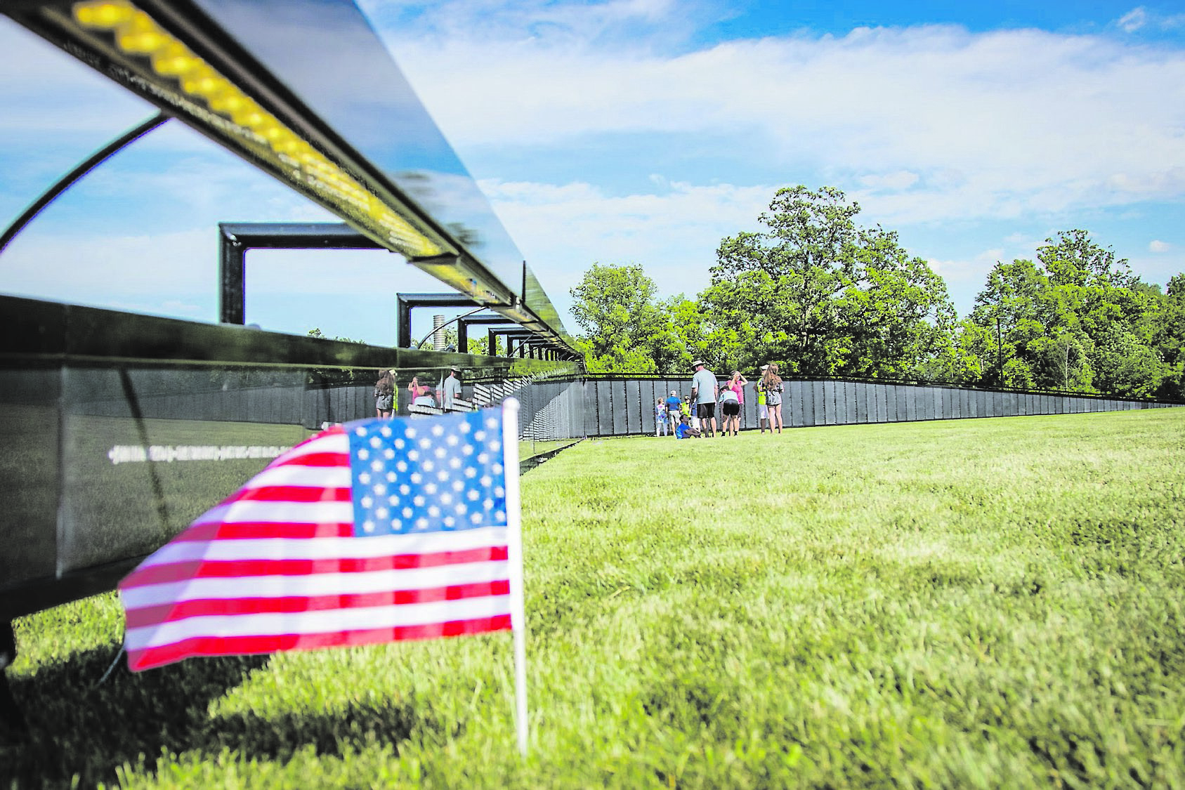 Visitors walk along the Vietnam Veterans Memorial Replica Wall.