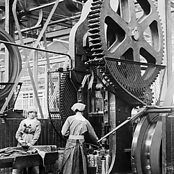 54635: Two women operate a shell case forming machine at the New Gun ...