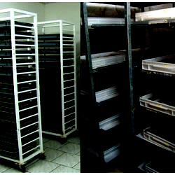 Trolleys with larval trays for biodegradation.