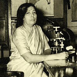Photograph of E.K. Janaki Ammal with a microscope